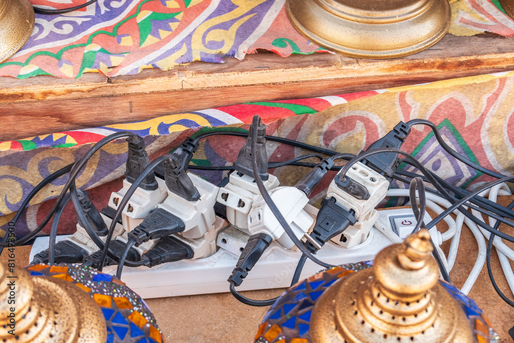 Old and damaged electric adapter power plug has many appliances are ...