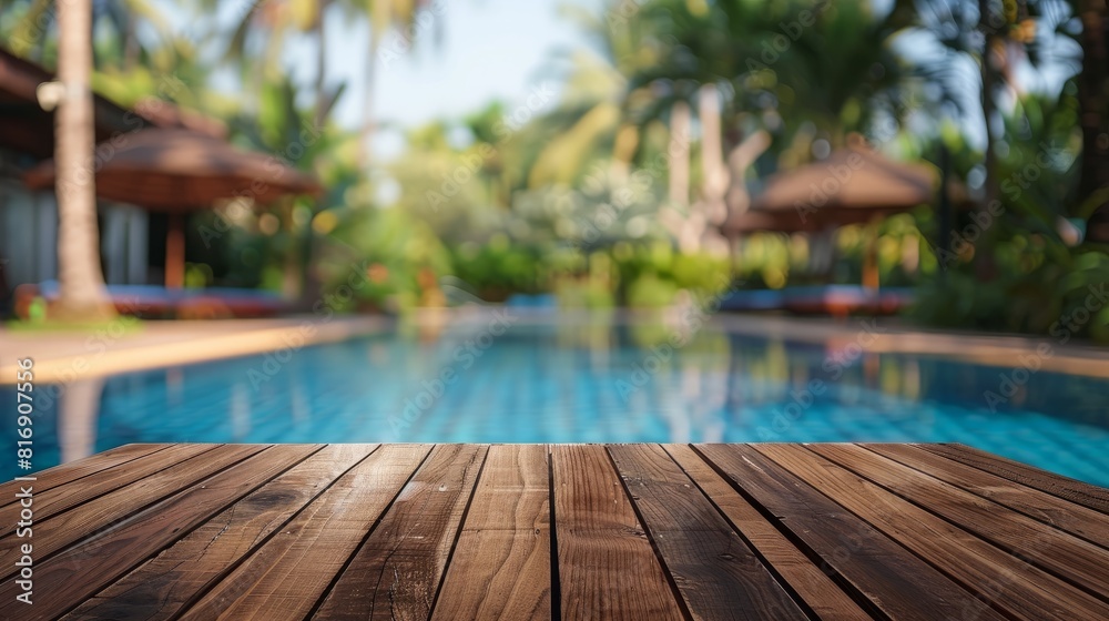 Image of wood table in front of swimming pool blur background. Brown ...