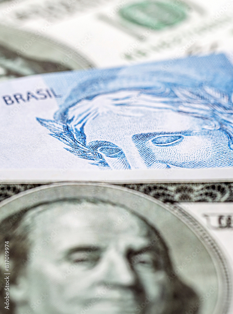 one hundred Brazilian banknotes and one hundred American dollars ...