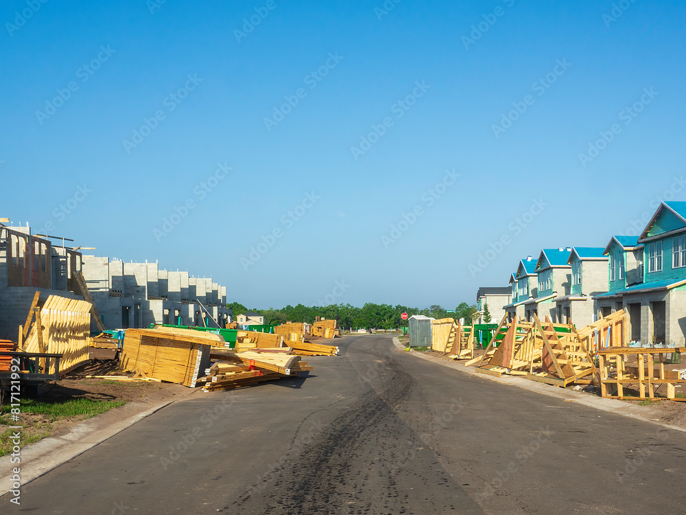 Perspective of a new asphalt street lined with townhouses under ...