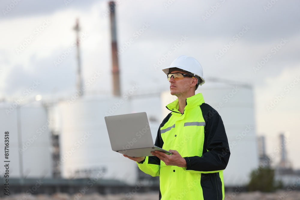 petrochemical engineer working with laptops outside the oil and gas ...