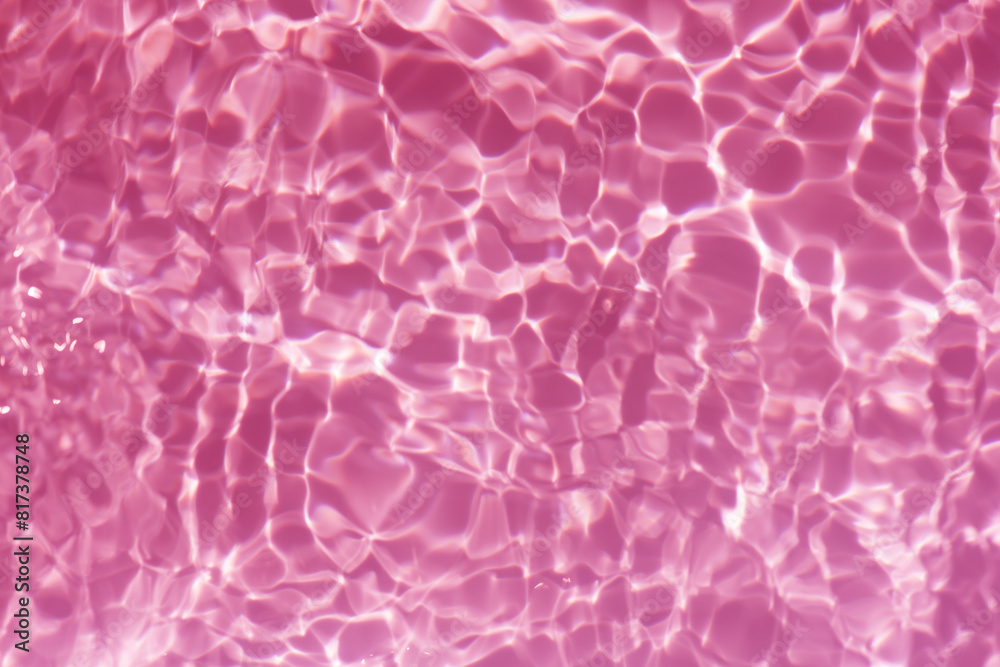 Pink water bubbles on the surface ripple. Defocus blurred transparent ...