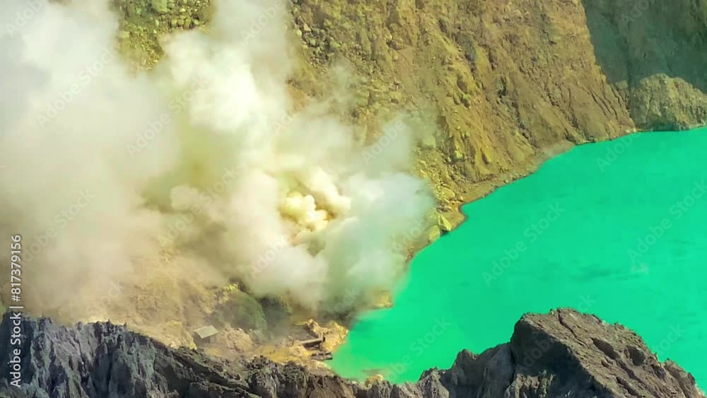 Active volcano erupting gas emission amidst a lush sulfur acid crater ...