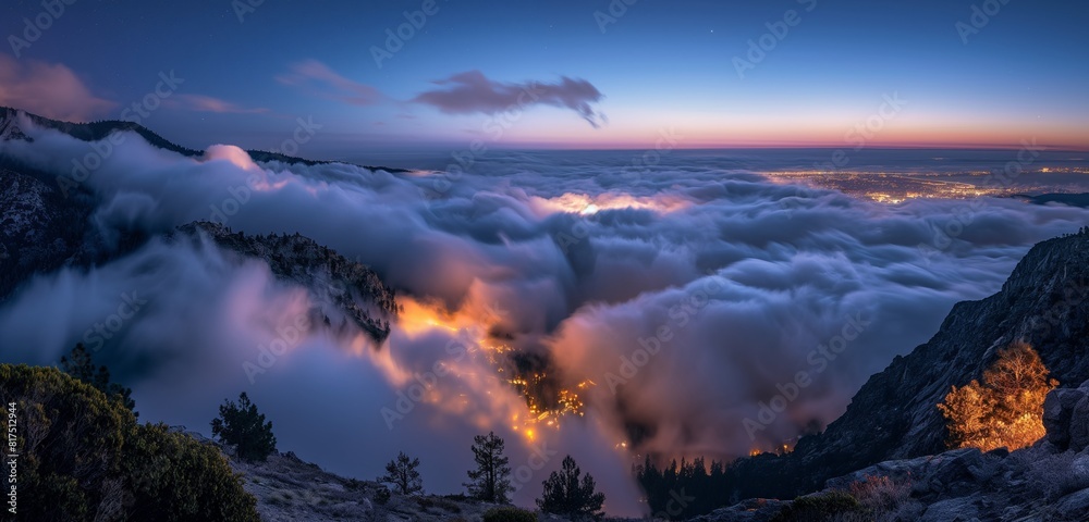 A mountaintop view of a cloud inversion at night, the clouds glowing ...