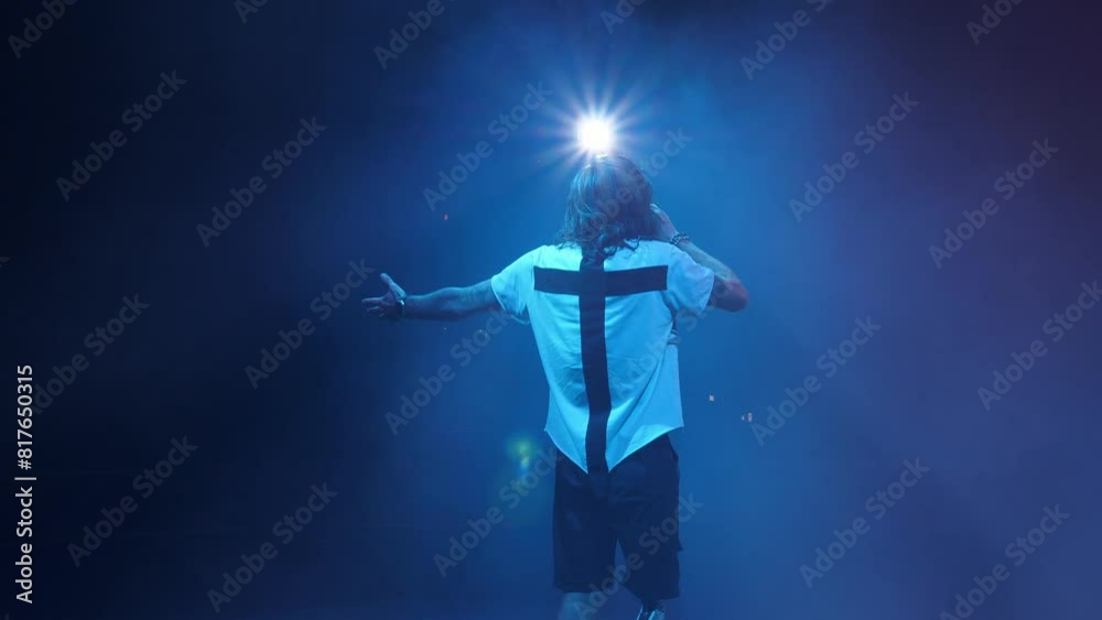 A circus presenter with a microphone in his hands stands in the circus ...