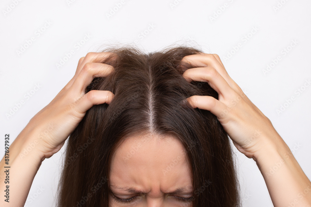 Cropped shot of a young woman scratching her head with her fingers ...