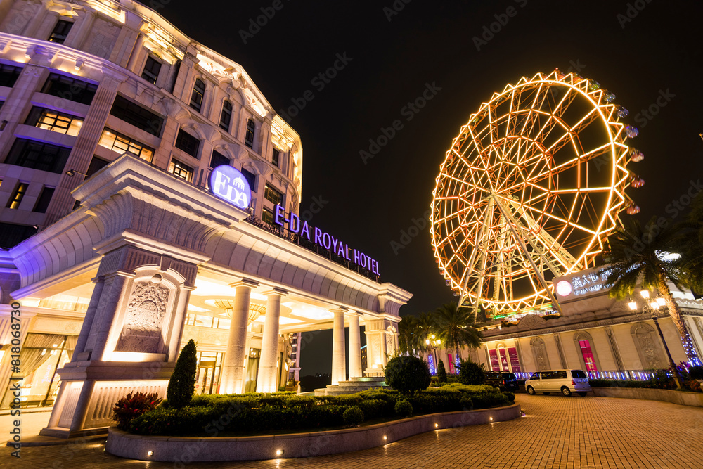 Kaohsiung, Taiwan- May 16, 2024: Night view of the E-DA Royal Hotel and the Ferris wheel at the ...