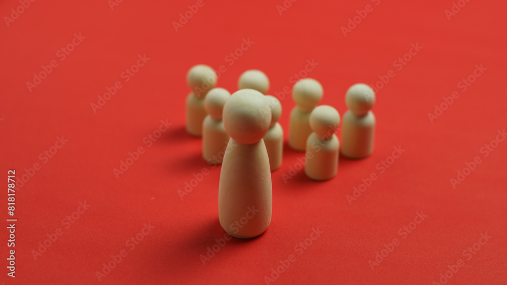 Leader wooden figures with followers lineup in orderly on white ...