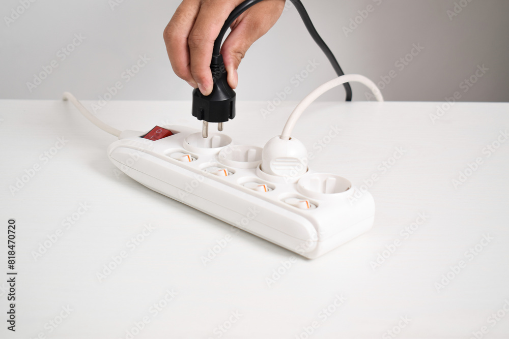 Hand holding electric plug, Multiple socket with connected plugs ... Hand holding electric plug, Multiple socket with connected plugs ...