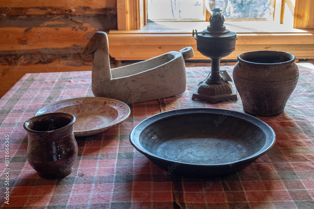 Kitchen utensils in an old wooden house. Antique tableware and ...