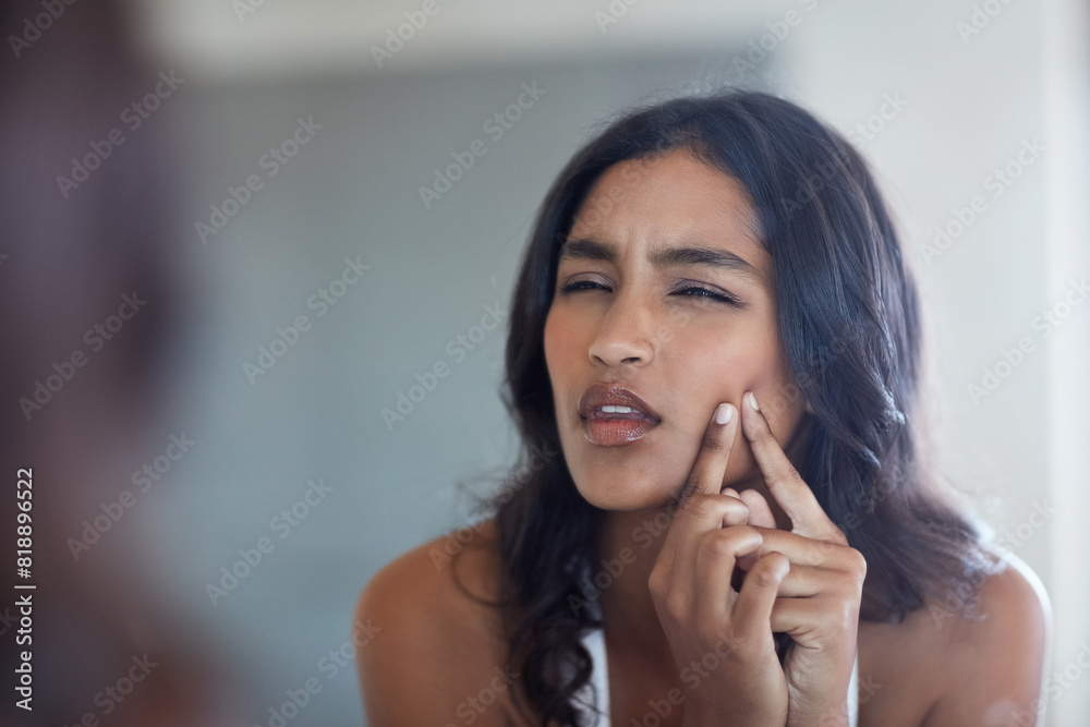 Frustrated, woman and face with hand for pimple popping in mirror ...