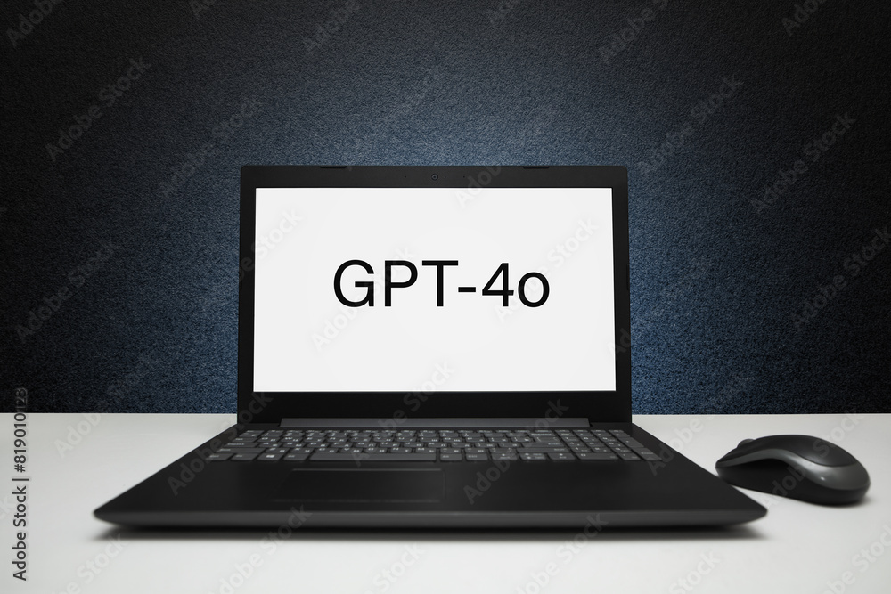 GPT-4o logo on screen laptop computer on black textured wall ...