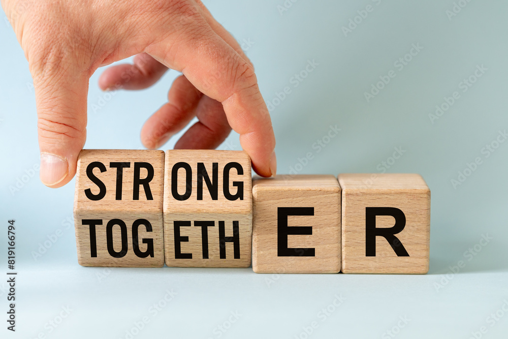 stronger together, businessman arranges the word stronger and together ...