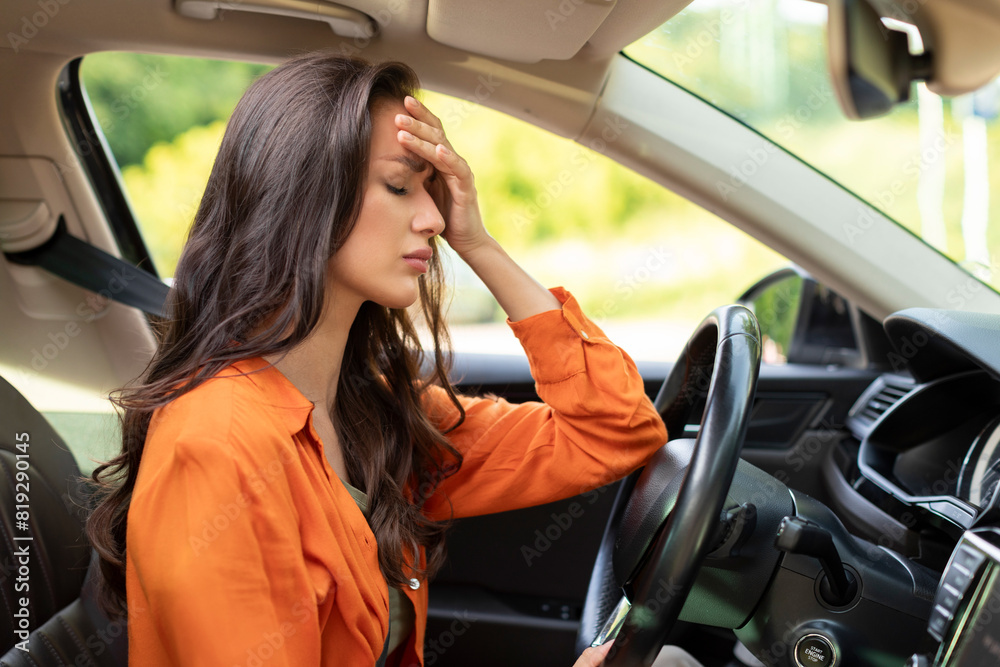 Stressed woman driving car feeling tired, lady touching head, sitting ...