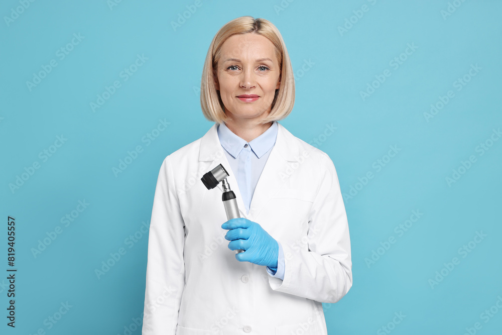 Dermatologist with dermatoscope on light blue background Stock Photo ...