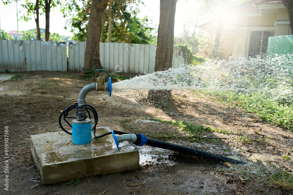 Groundwater well, Artesian aquifer with flowing water in the garden ...