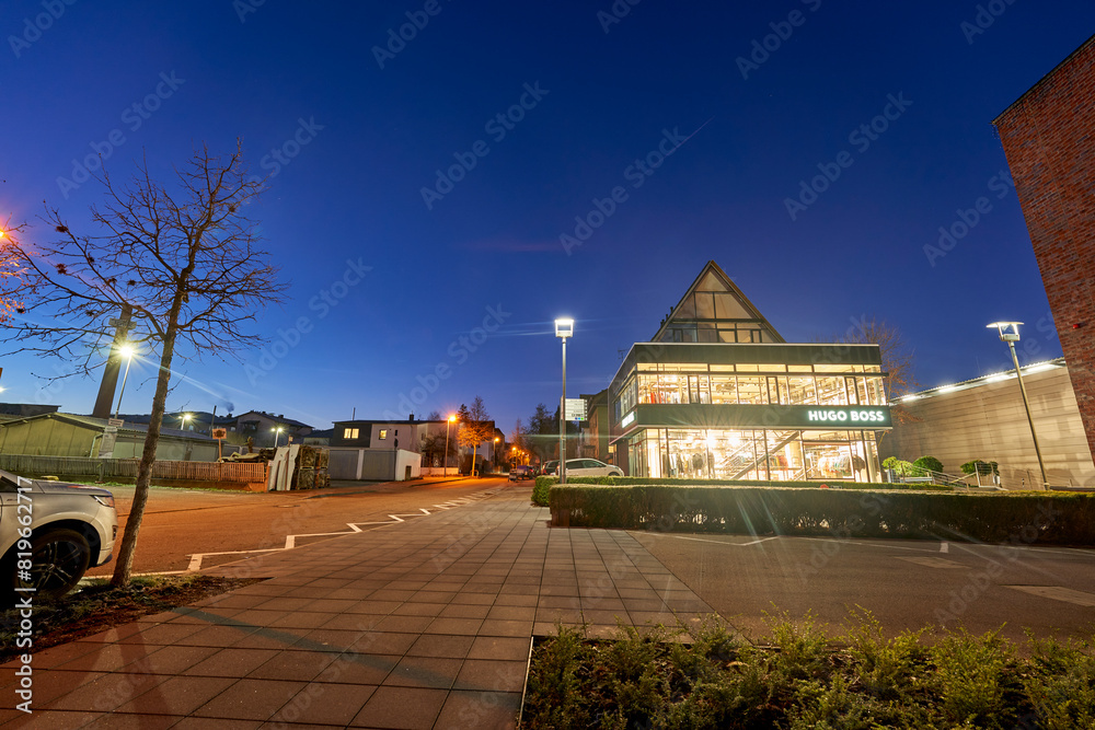 Hugo Boss building in the outlet city. Illuminated company building ...