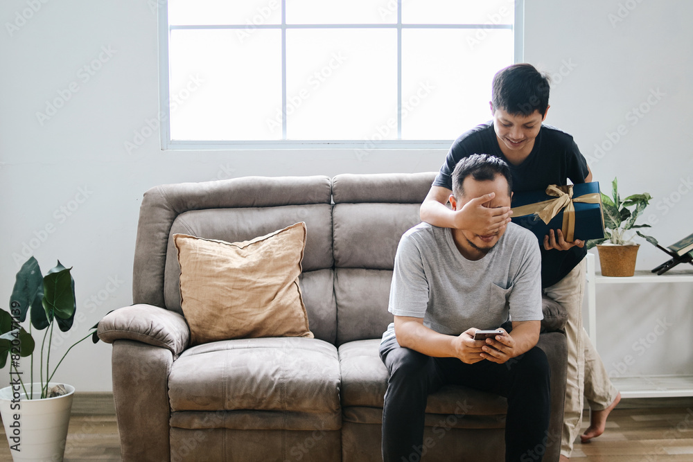 Son Closing Father's Eyes With Hands To Suprising Father Giving Gift ...