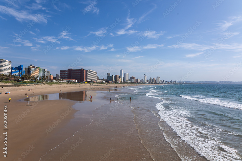 A perspective view of the beachfront with waves, exposed beach sand at ...