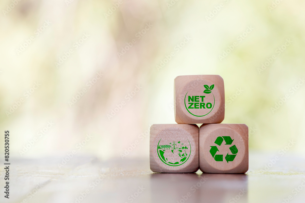 Net zero icon at wood box on green leaf blur in golden light morning ...