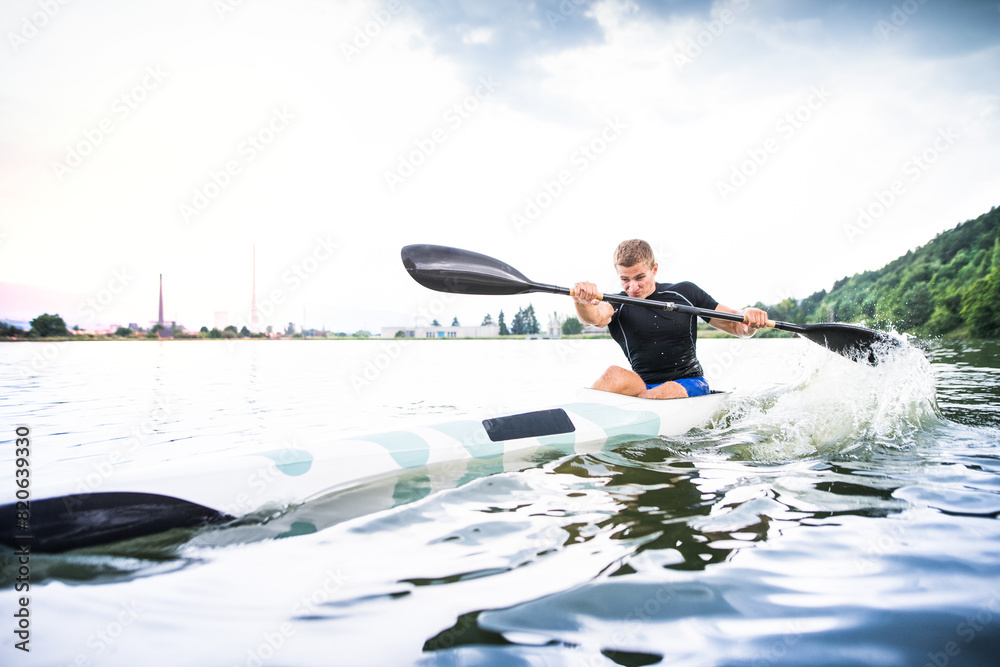 Canoeist man sitting in canoe holding paddle, in water. Concept of ...
