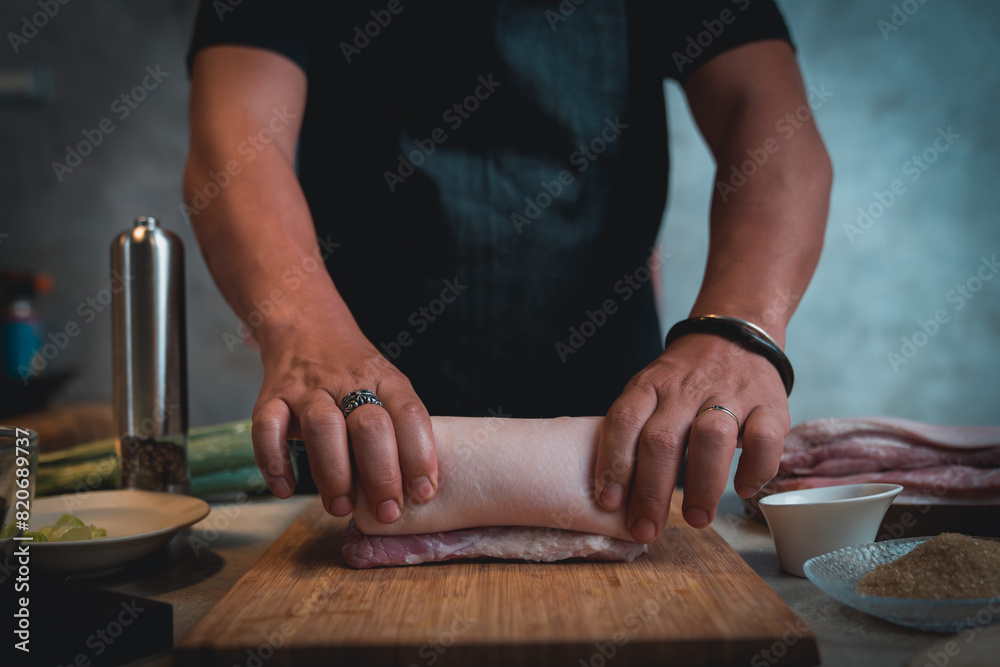Men tie ropes and cut pork to make Japanese-style pork slices. Stock ...