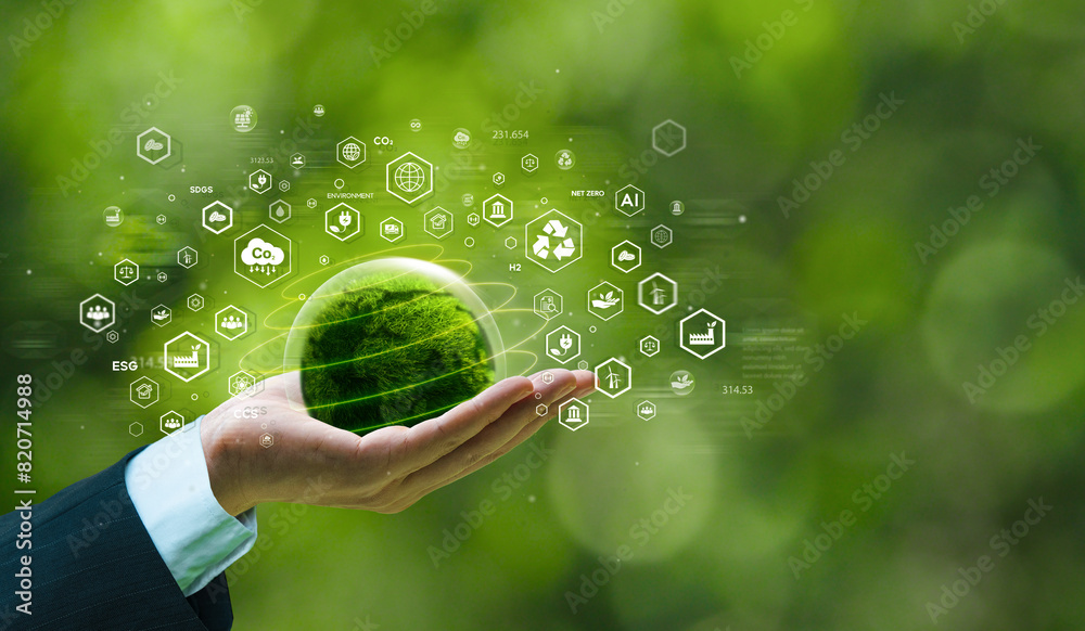 Businessman's hand holds green planet with ESG, net zero, carbon co2 ...