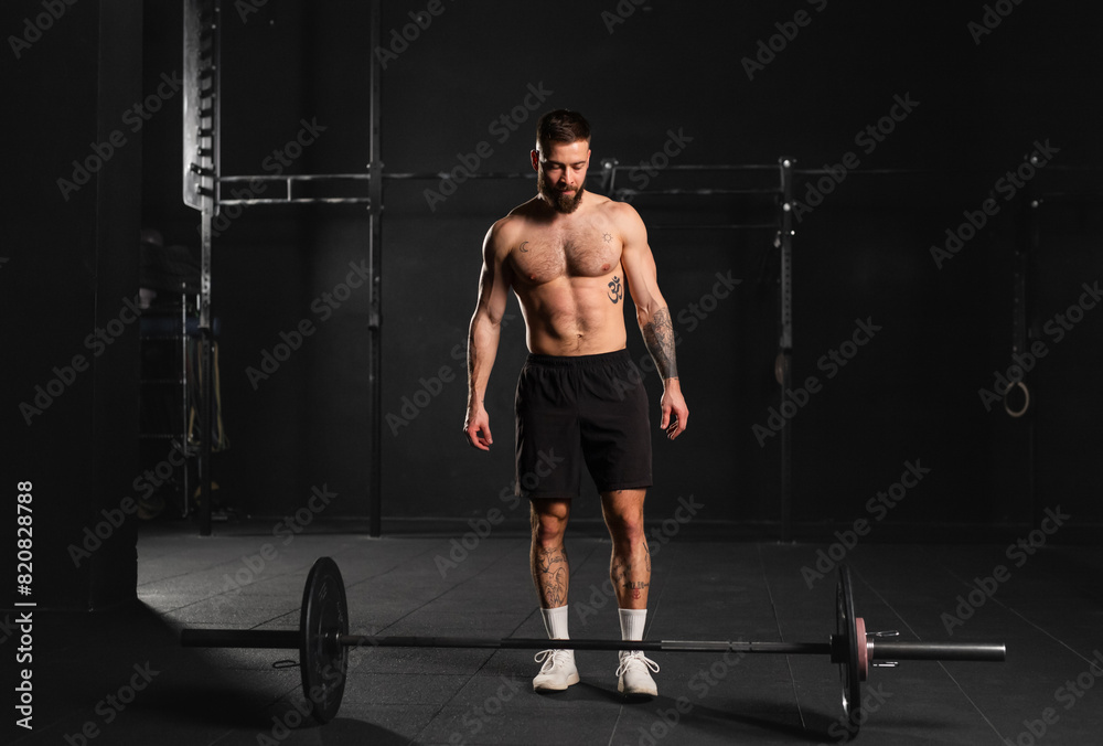 Strong man preparing for barbell lift, overhead squat, standing by ...