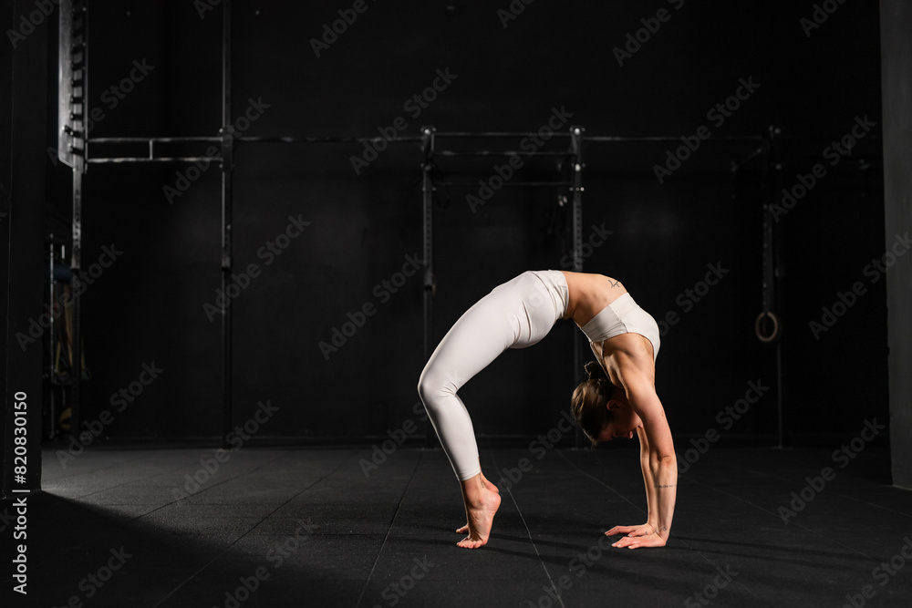 Woman doing acroyoga alone, solo. Flexibile woman focusing on yoga and ...