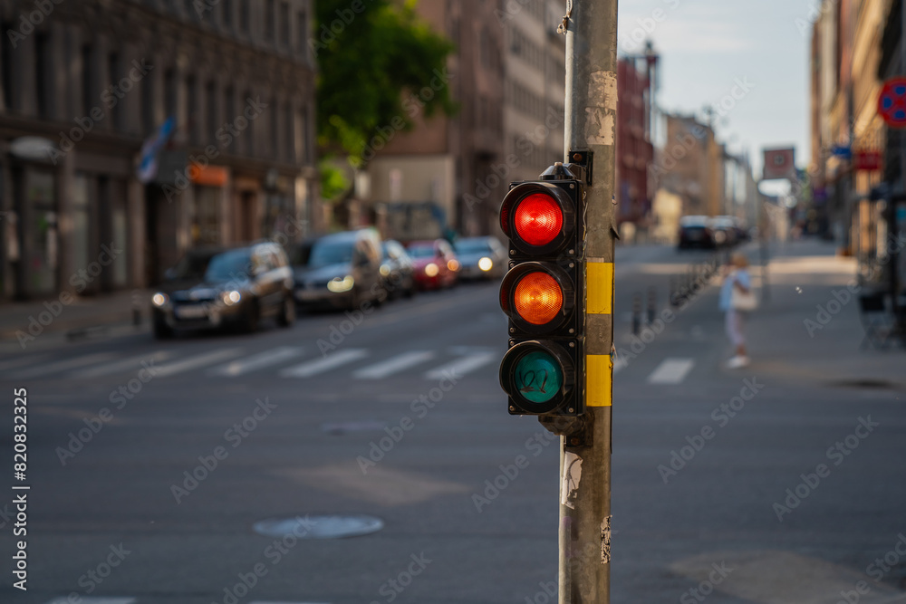 Traffic light in medium level showing colors with cars and street in ...