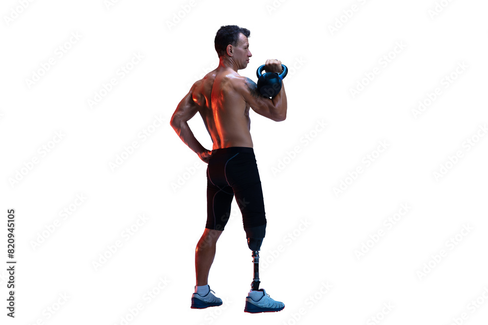 Muscular shirtless man, athlete with prosthetic leg lifting kettlebell ...
