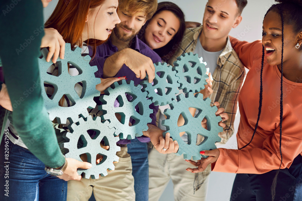 Team of diverse people connecting mechanical cogs. Group of smiling ...