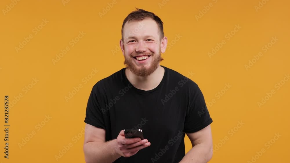 Man Scrolling Through Social Media on a Yellow Background, Expressing ...