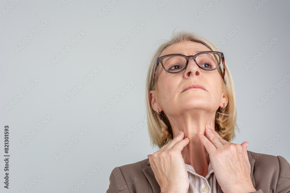Woman thyroid gland control. Senior lady sweeping the laryngeal ...