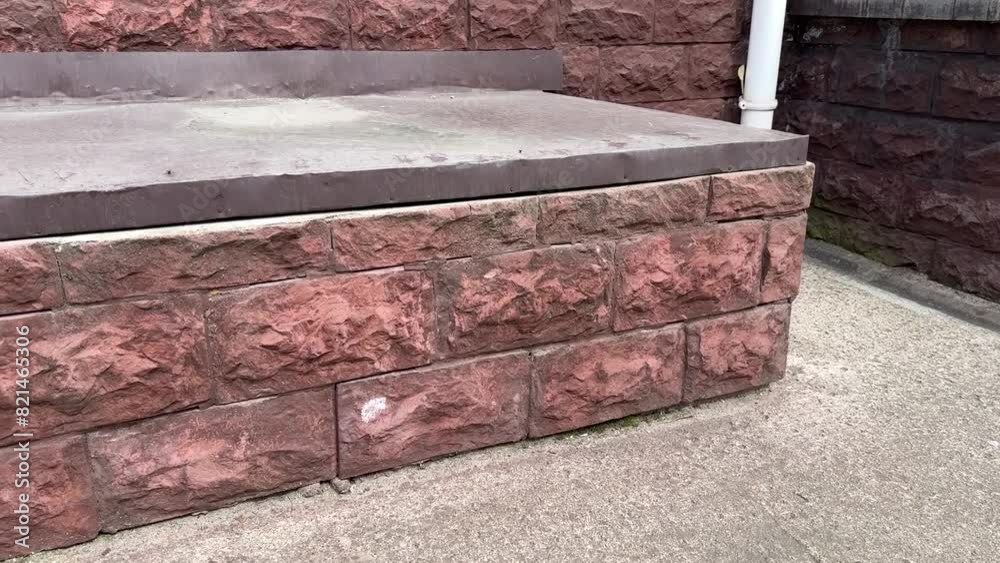 Basement entrance in the building of house has window is located below ...