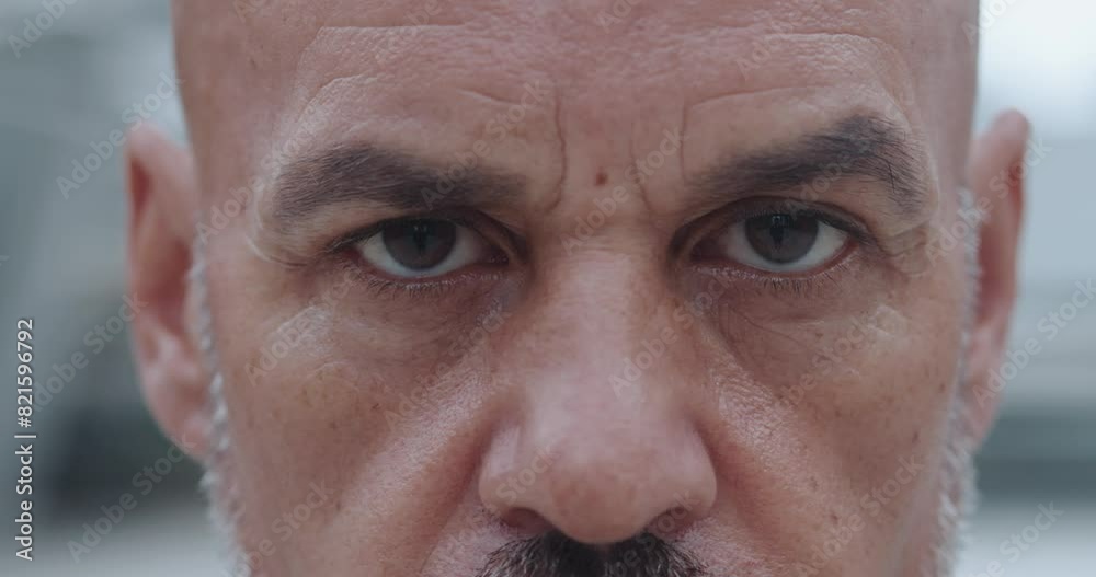 Close-up angry man gaze straight into camera. Eyes is full of ...
