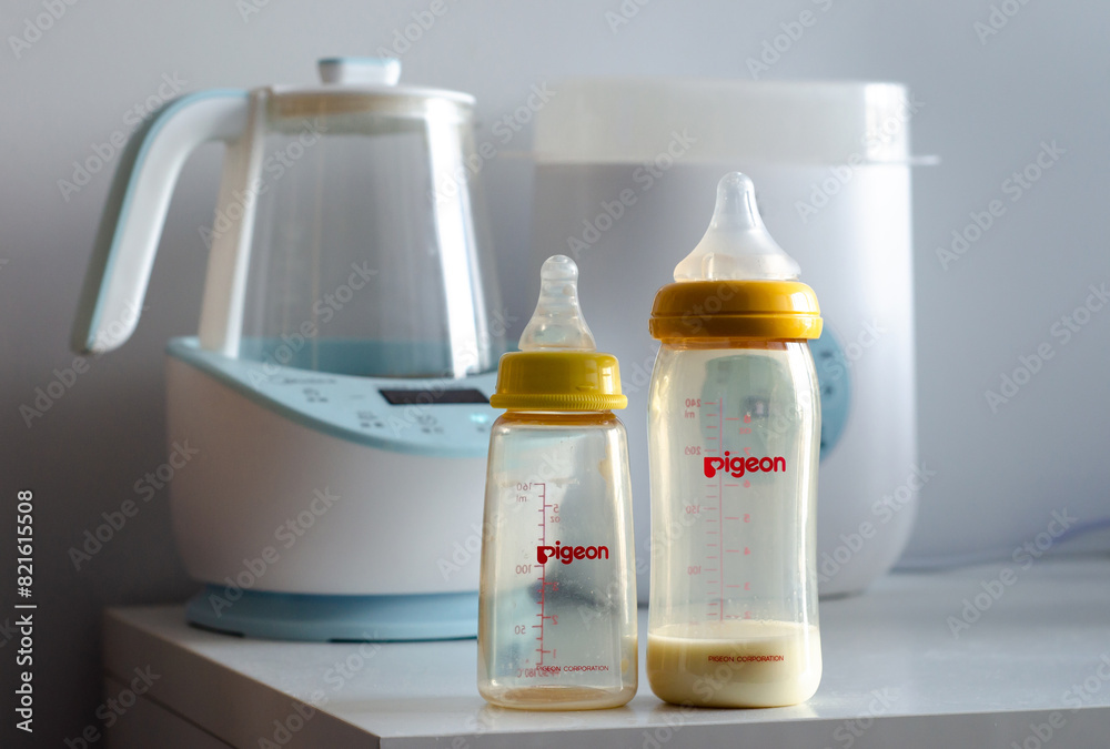 Two Pigeon baby feeding bottles with leftover infant formula milk are ...