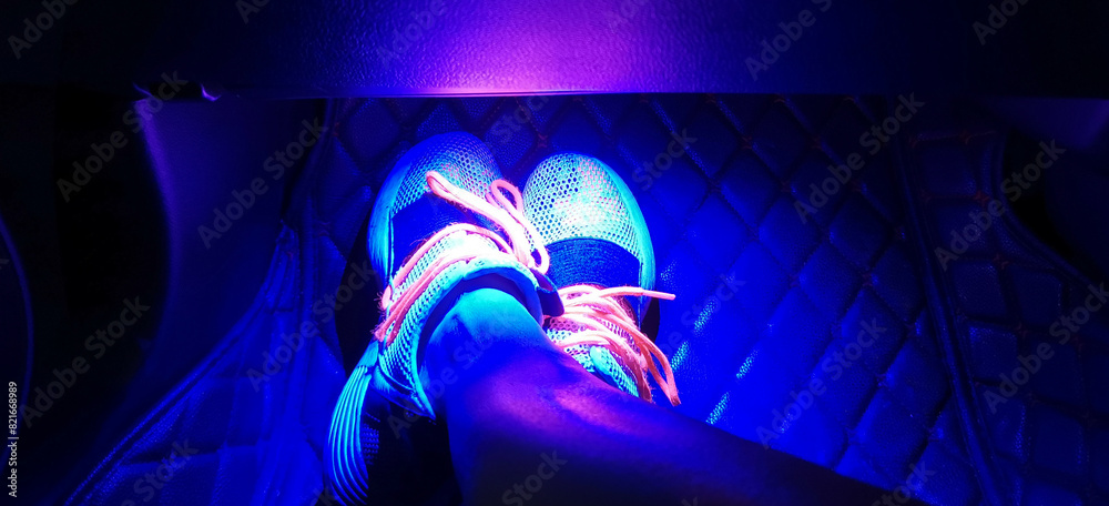 Shoes that were illuminated by blacklight caused the reflection of the ...
