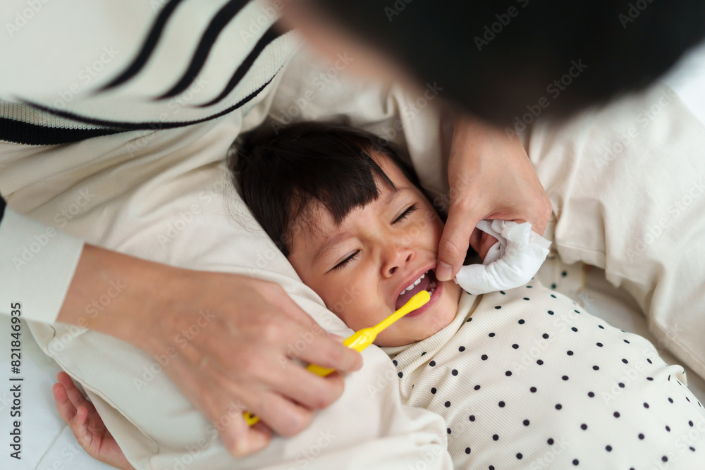 mother brushing her daughters teeth. crying baby with tooth brush Stock ...