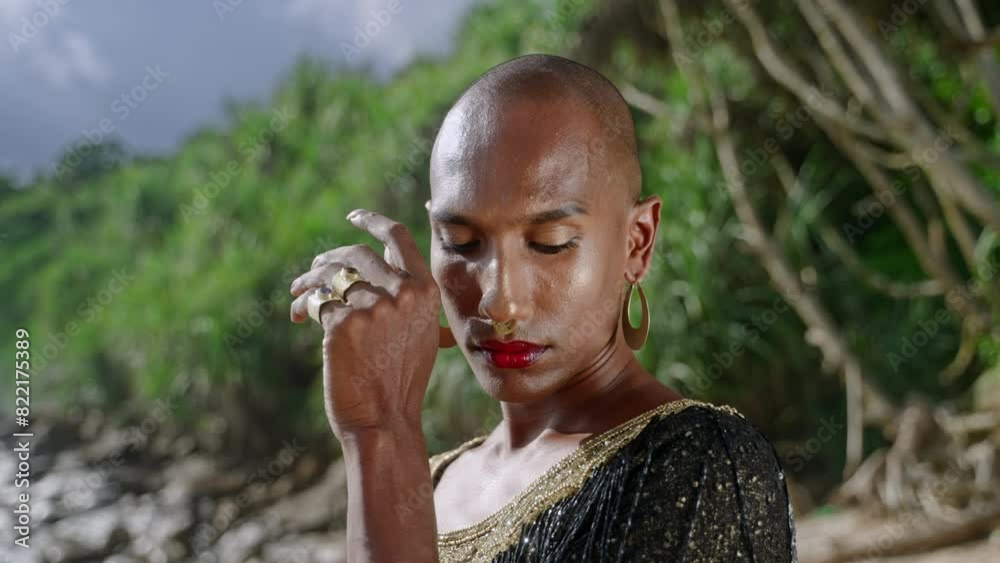 Vidéo Stock Androgynous person of color looks at camera with moody face ...