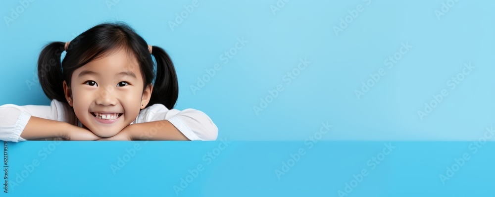 Blue background Happy Asian child Portrait of young beautiful Smiling ...