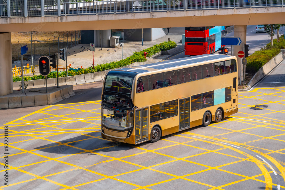 Double-decker city shuttle bus at an intersection with markings rides ...