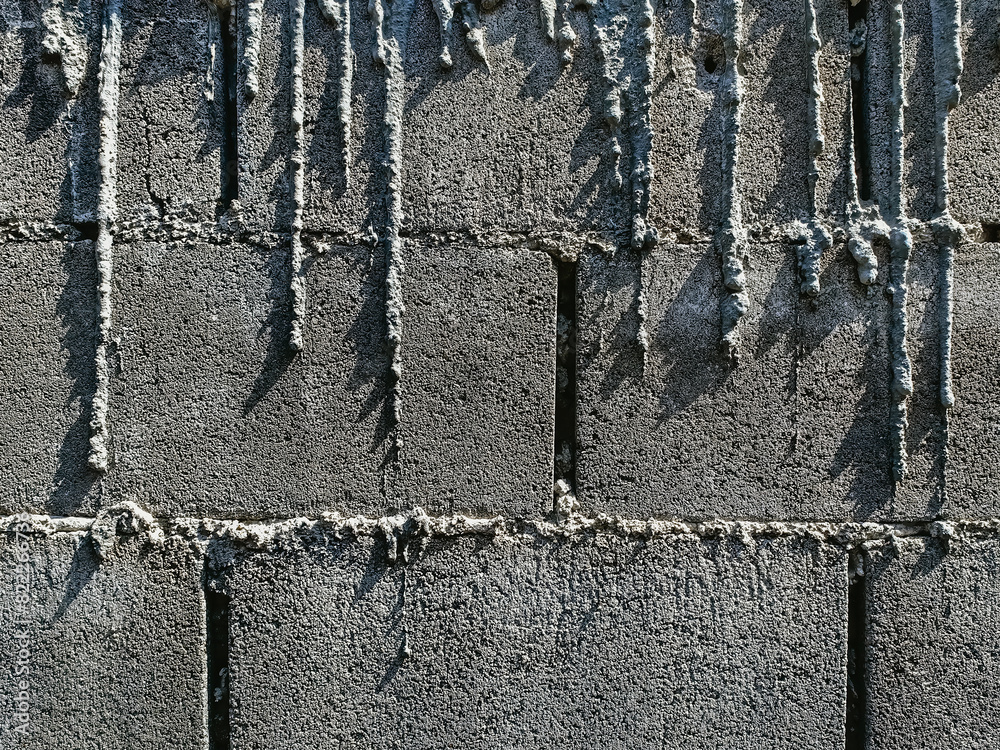 Dry cement drips on bricks wall. Mortar dripping and running down the ...