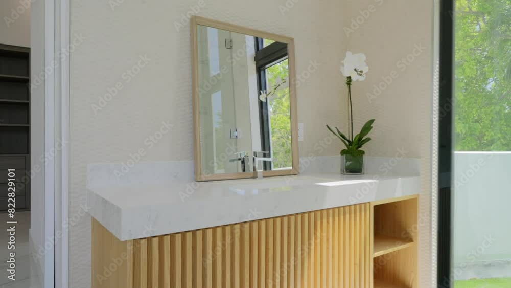 Elegant bathroom vanity area with clear view of rectangular mirror ...