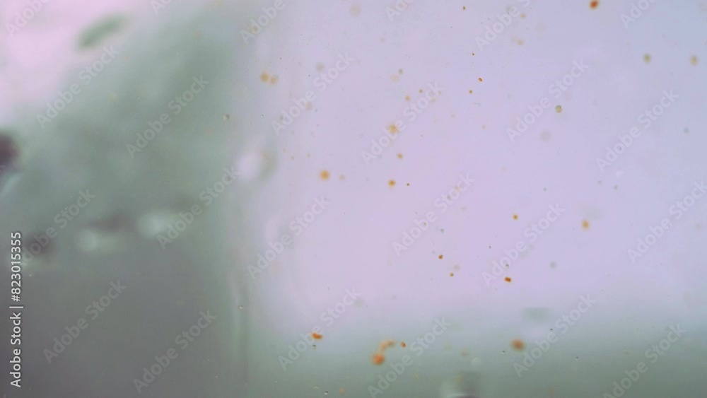Paint particles. Ink bubbles. Defocused gray orange color dripping ...