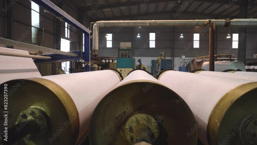 Rows Of Large Spinning Rollers With White Textile Fabric Inside Factory ...