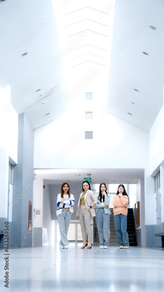 Four women are walking down a hallway in a building Stock Photo | Adobe ...