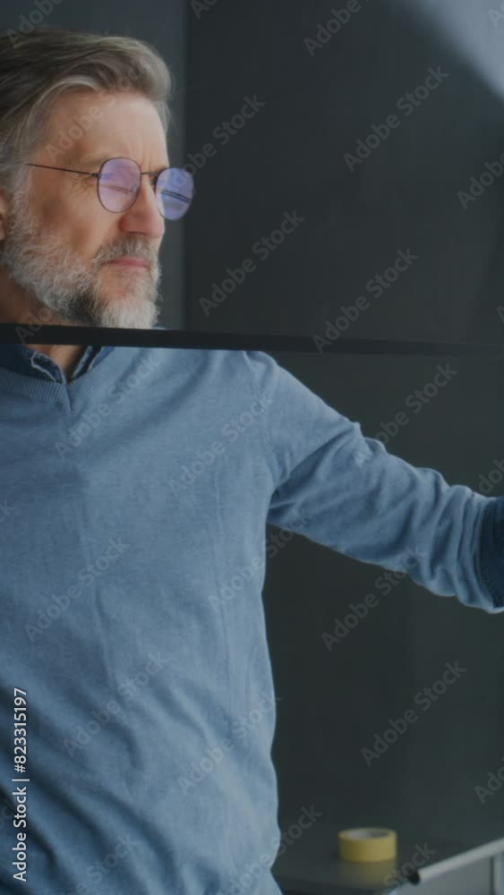 Automotive male engineer creating sketch with duct tape on paper ...