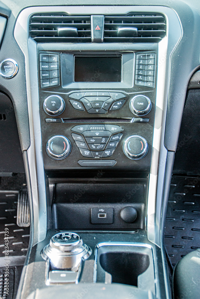 Radio in the car with a lot of toggle switches and buttons and a ...