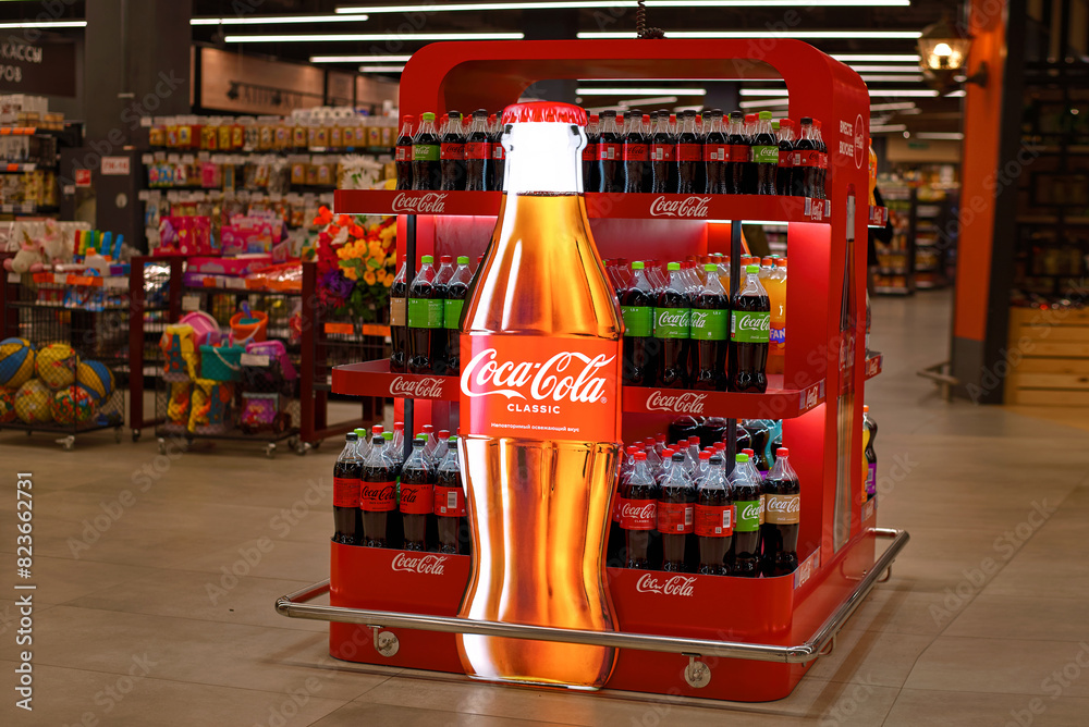 Minsk, Belarus. Apr 28, 2024. Retail display stand featuring rows of Coca-Cola bottles. Grocery ...